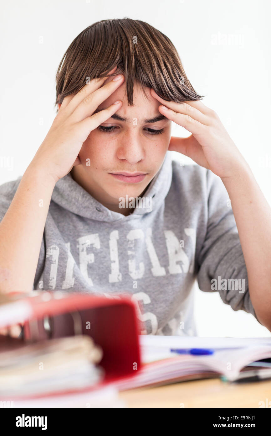 Teenage boy doing homework Stock Photo - Alamy
