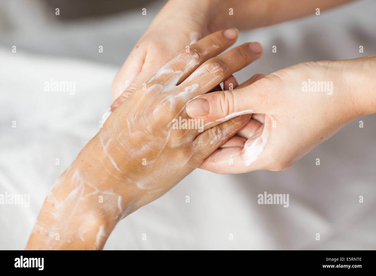 Applying moisturizing cream on hands Stock Photo - Alamy