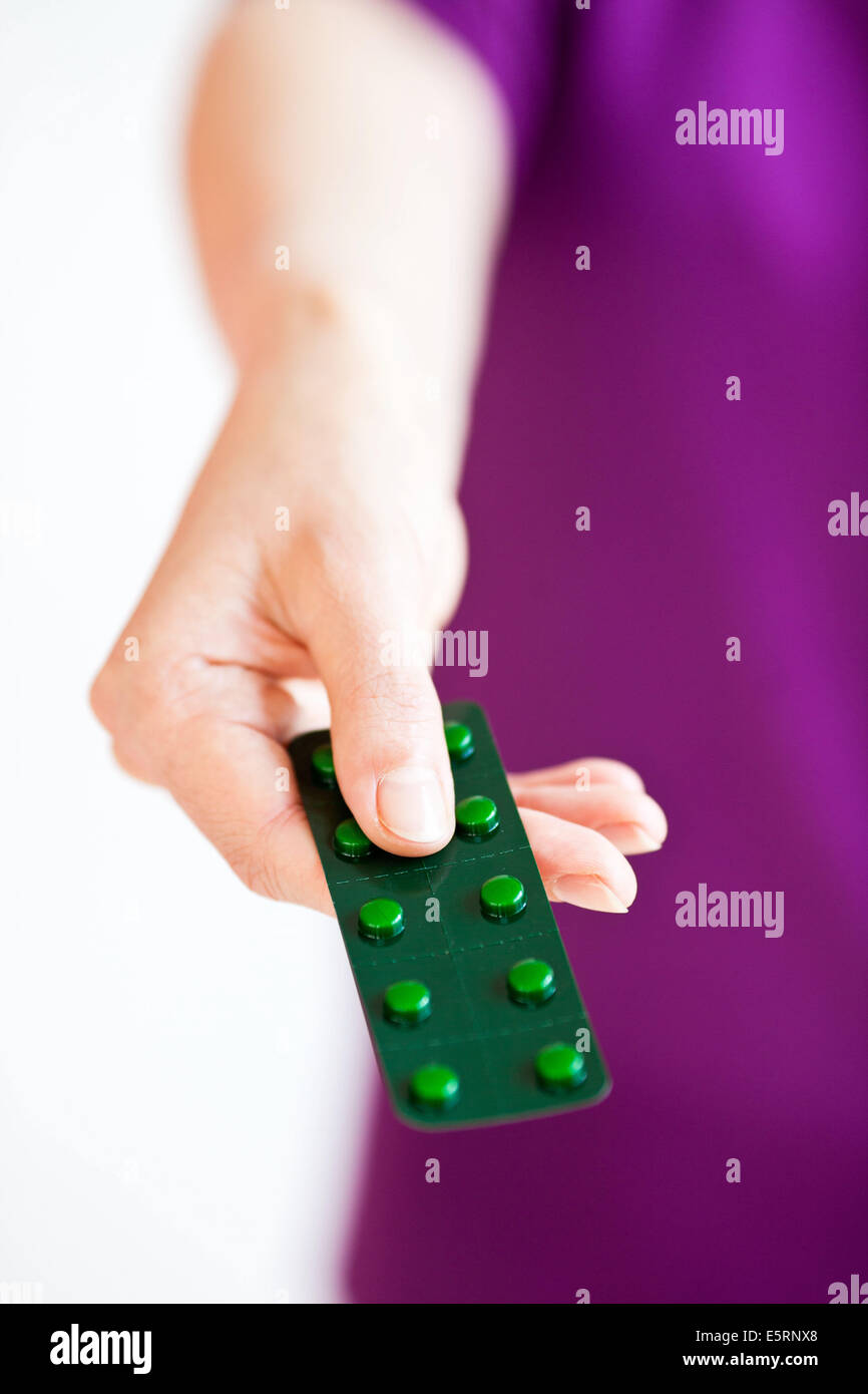Woman taking medication Stock Photo - Alamy