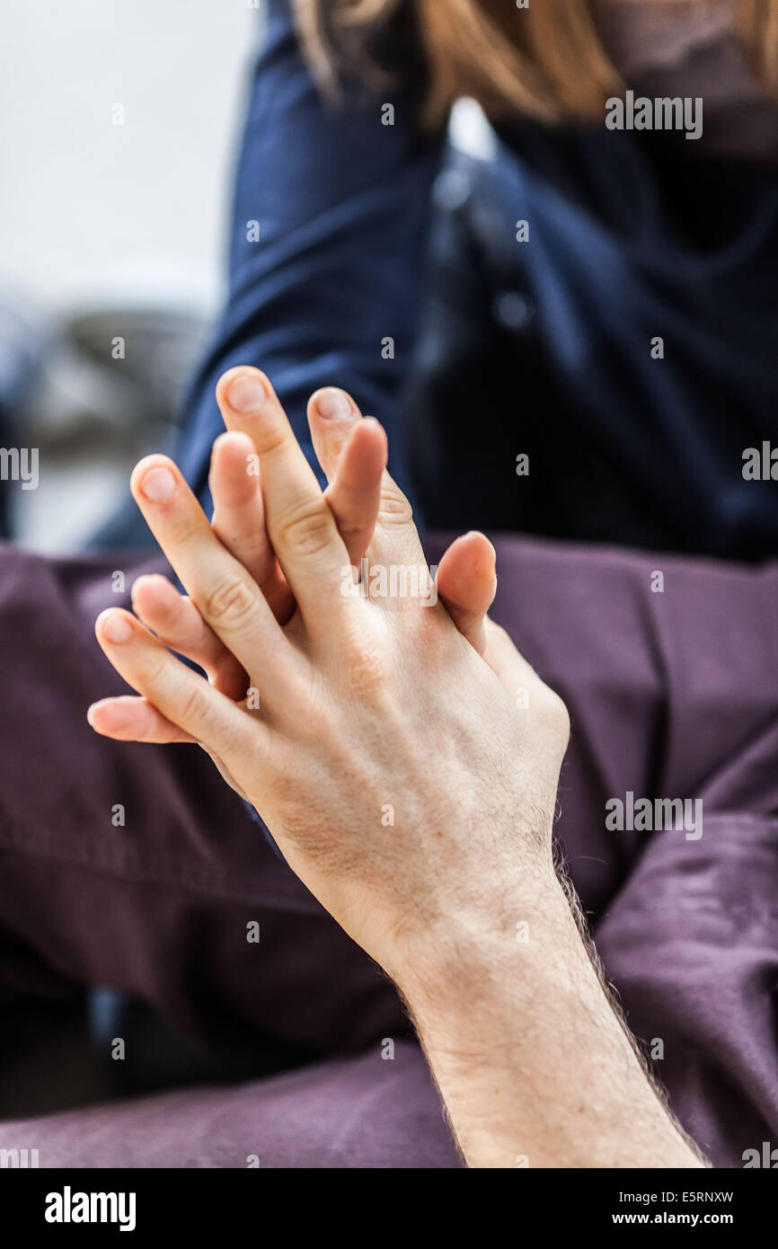 Hands clasped together Stock Photo - Alamy