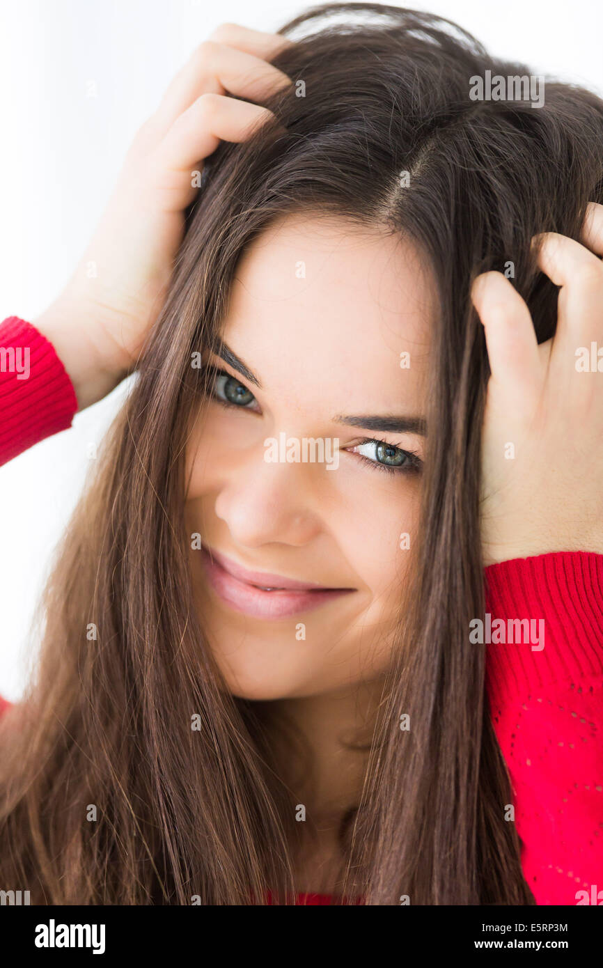 Woman touching hair Stock Photo - Alamy