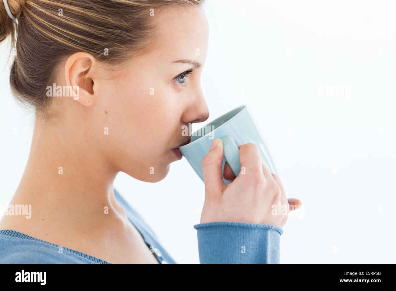 Woman drinking hot beverage Stock Photo - Alamy
