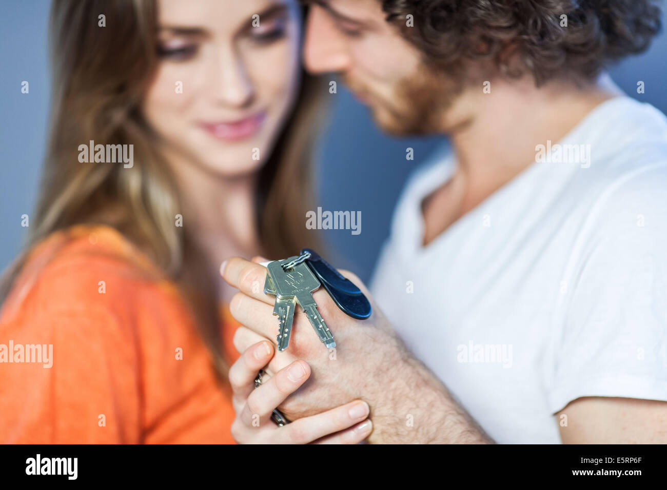 Couple with keys Stock Photo - Alamy