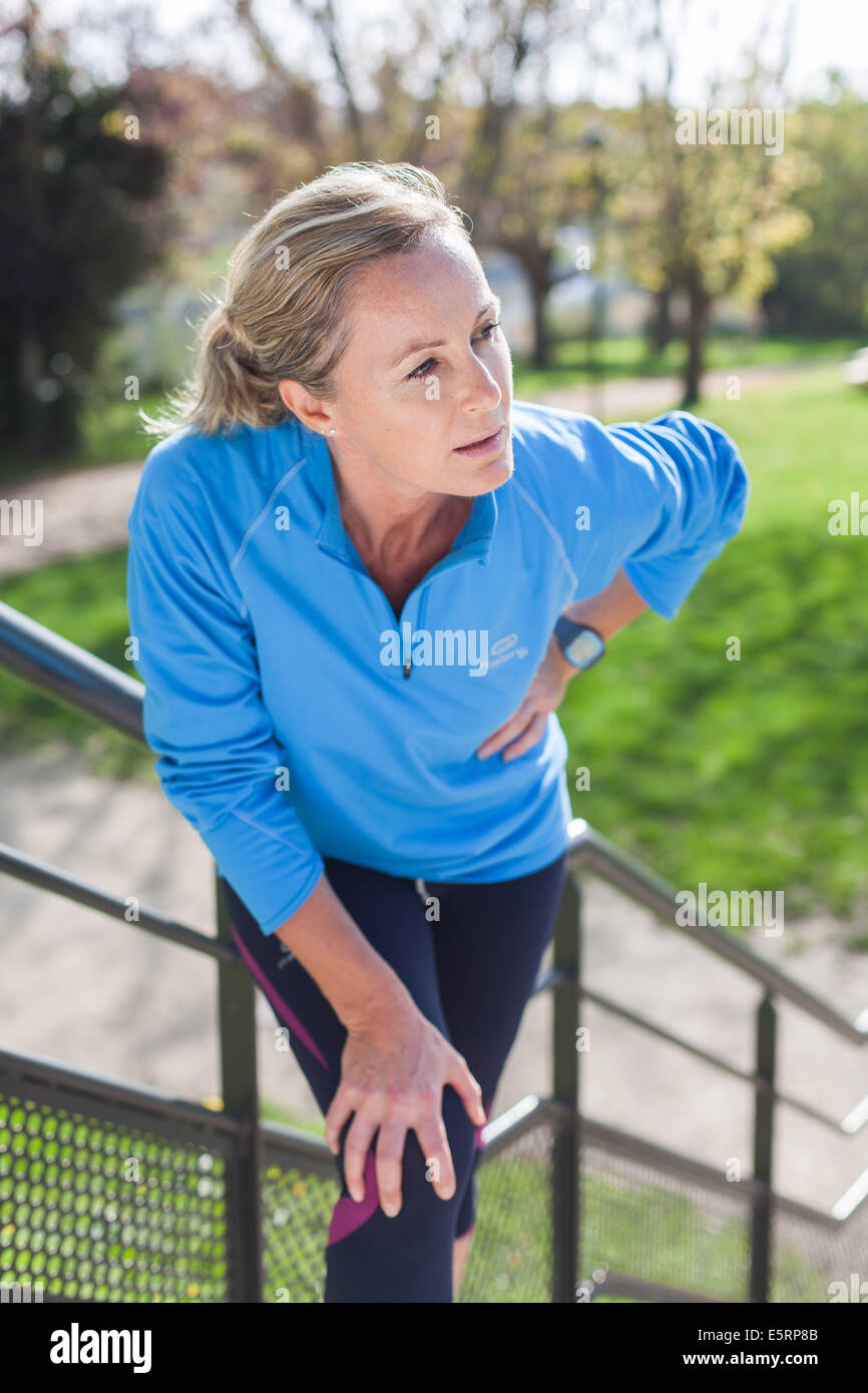 Woman suffering from a stitch Stock Photo - Alamy