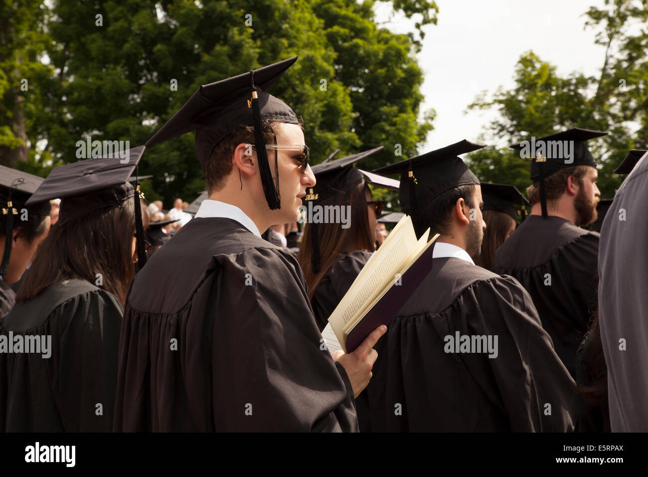 Graduating students parade into the seating area before their ...
