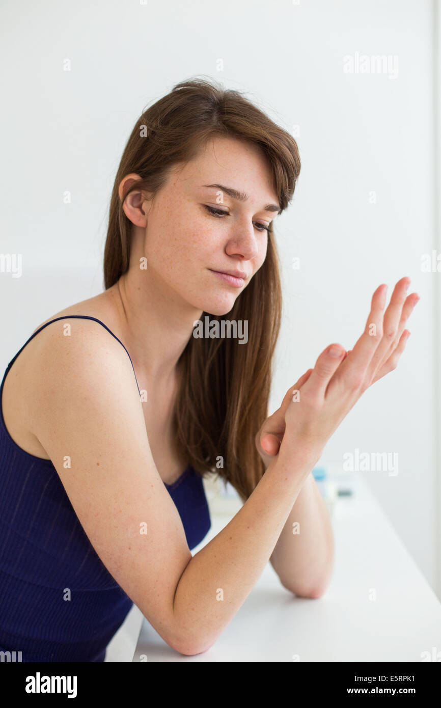 Woman looking at her hands Stock Photo - Alamy