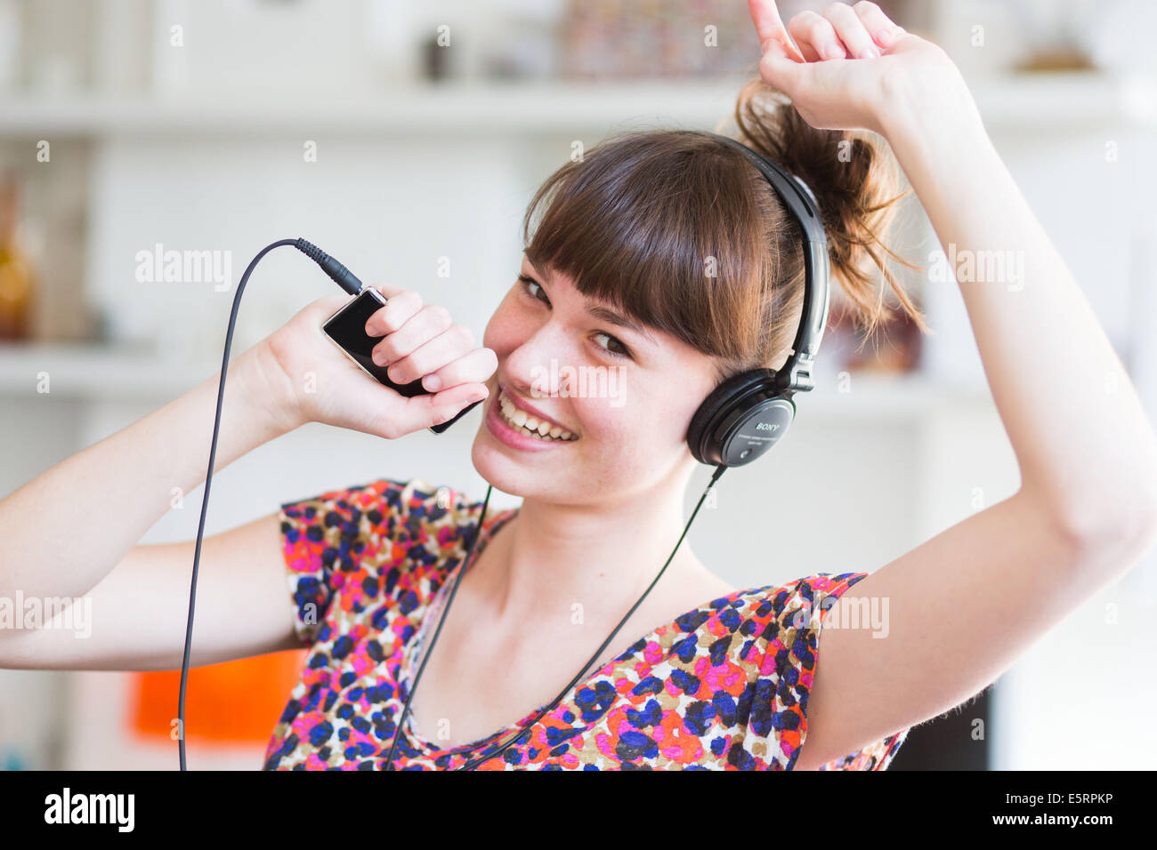 Woman listening to music on an ipod MP3 player Stock Photo - Alamy