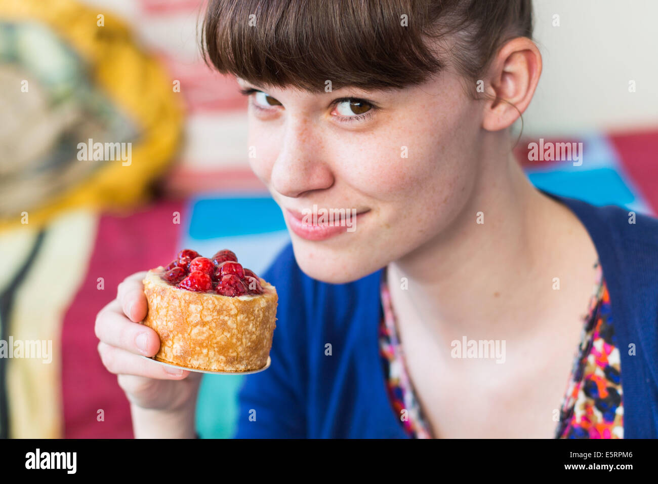 Woman eating pastry Stock Photo - Alamy