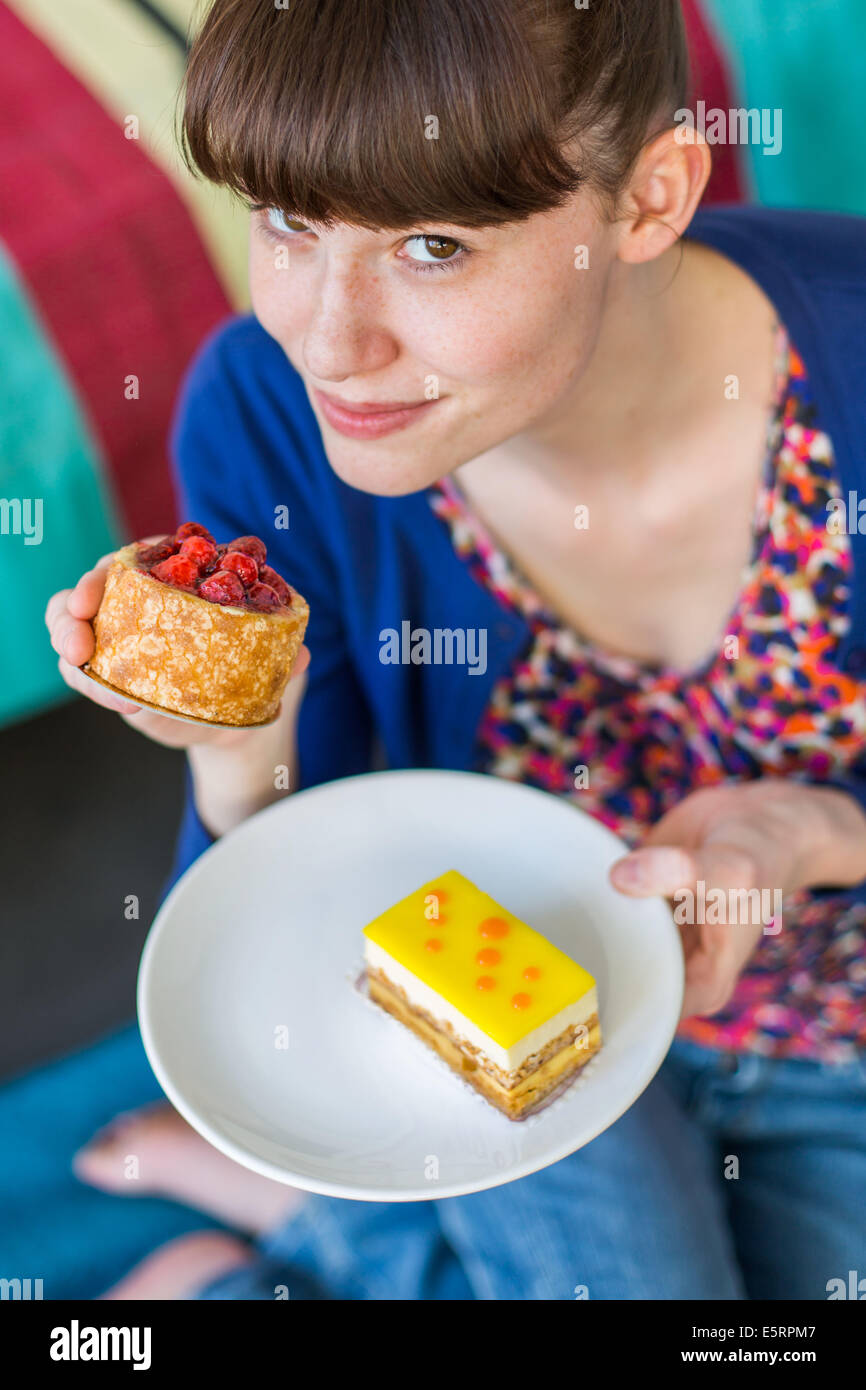 Woman eating pastry Stock Photo - Alamy
