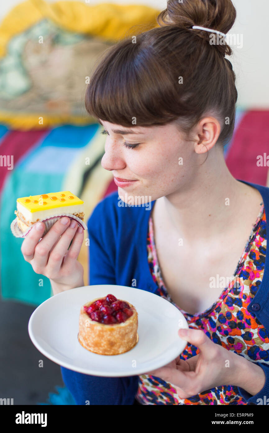Woman eating pastry Stock Photo - Alamy