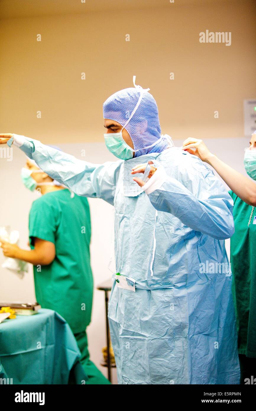 Surgical team getting dressed before surgery Stock Photo - Alamy