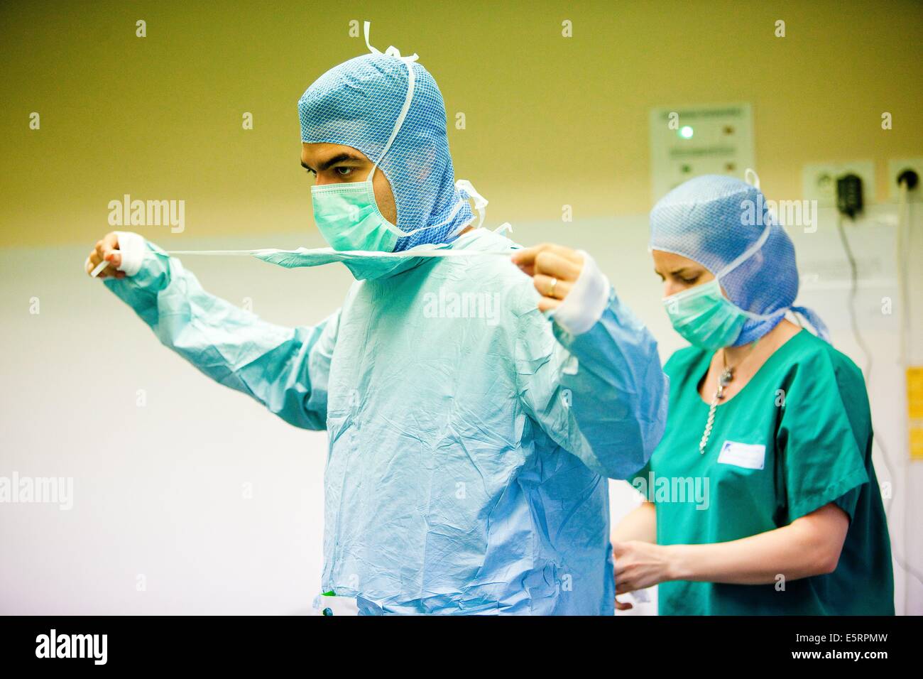 Surgical team getting dressed before surgery Stock Photo - Alamy