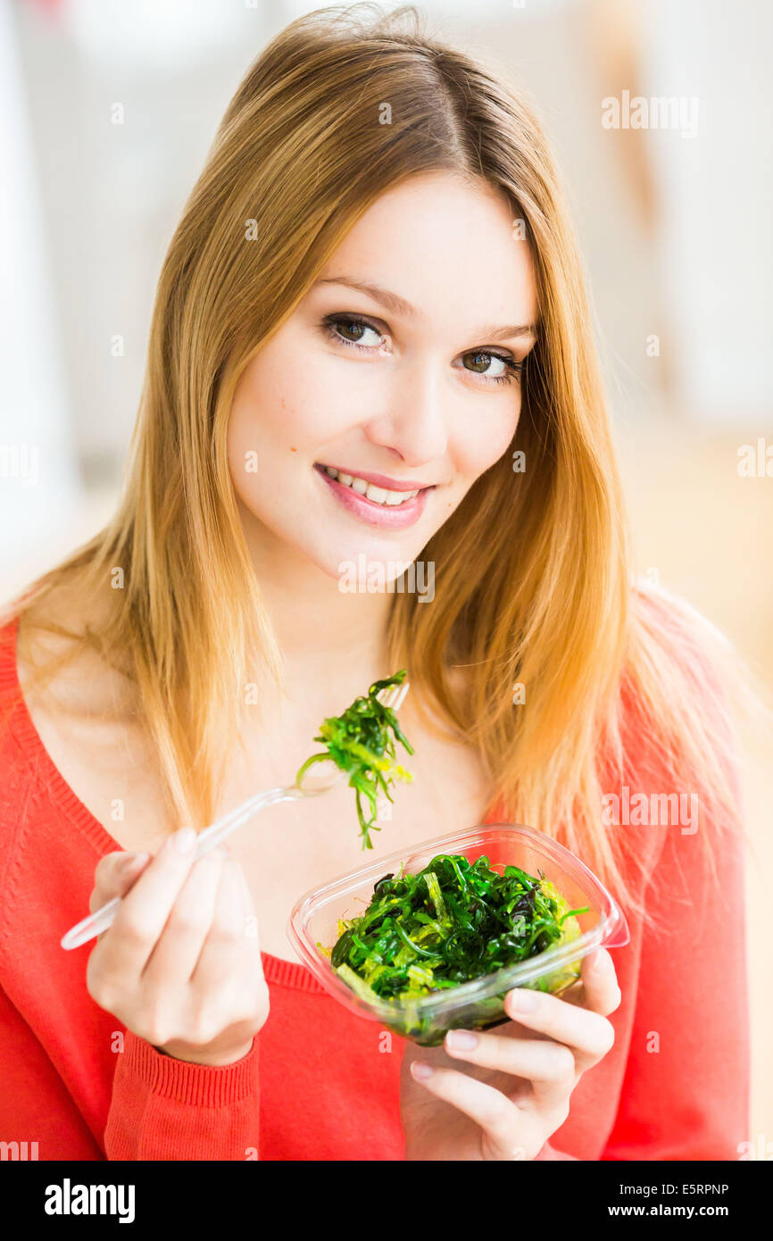 Woman eating edible seaweed Stock Photo - Alamy
