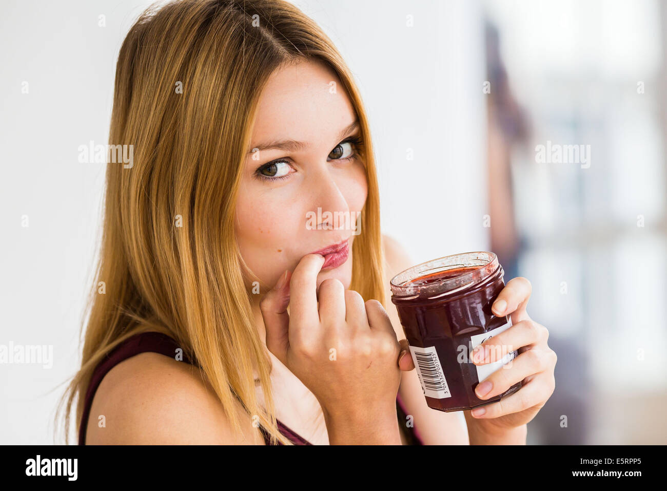Woman eating jam Stock Photo - Alamy