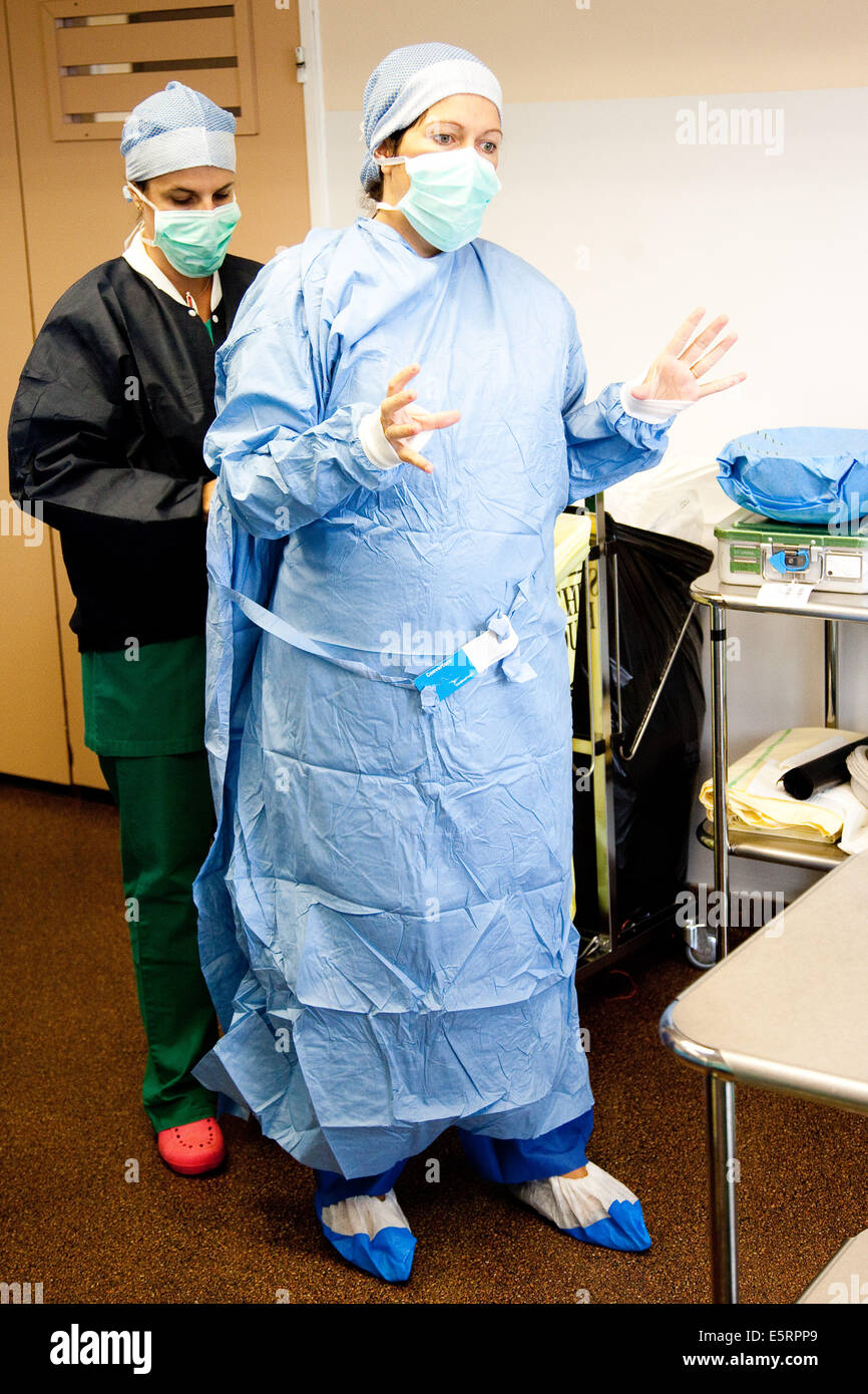 Surgical team getting dressed before surgery, St Antoine hospital ...