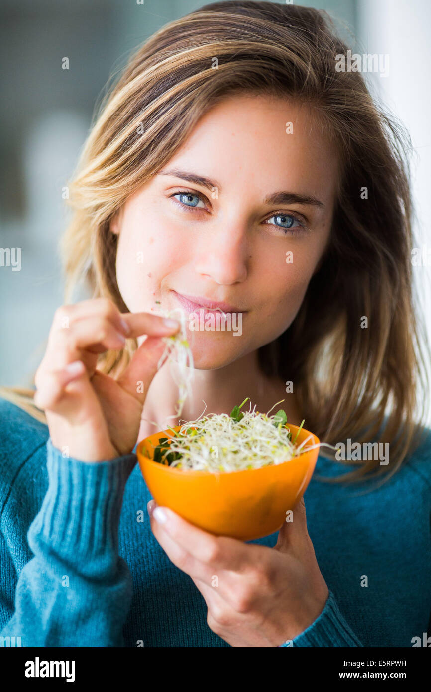 Woman eating sprouts Stock Photo - Alamy