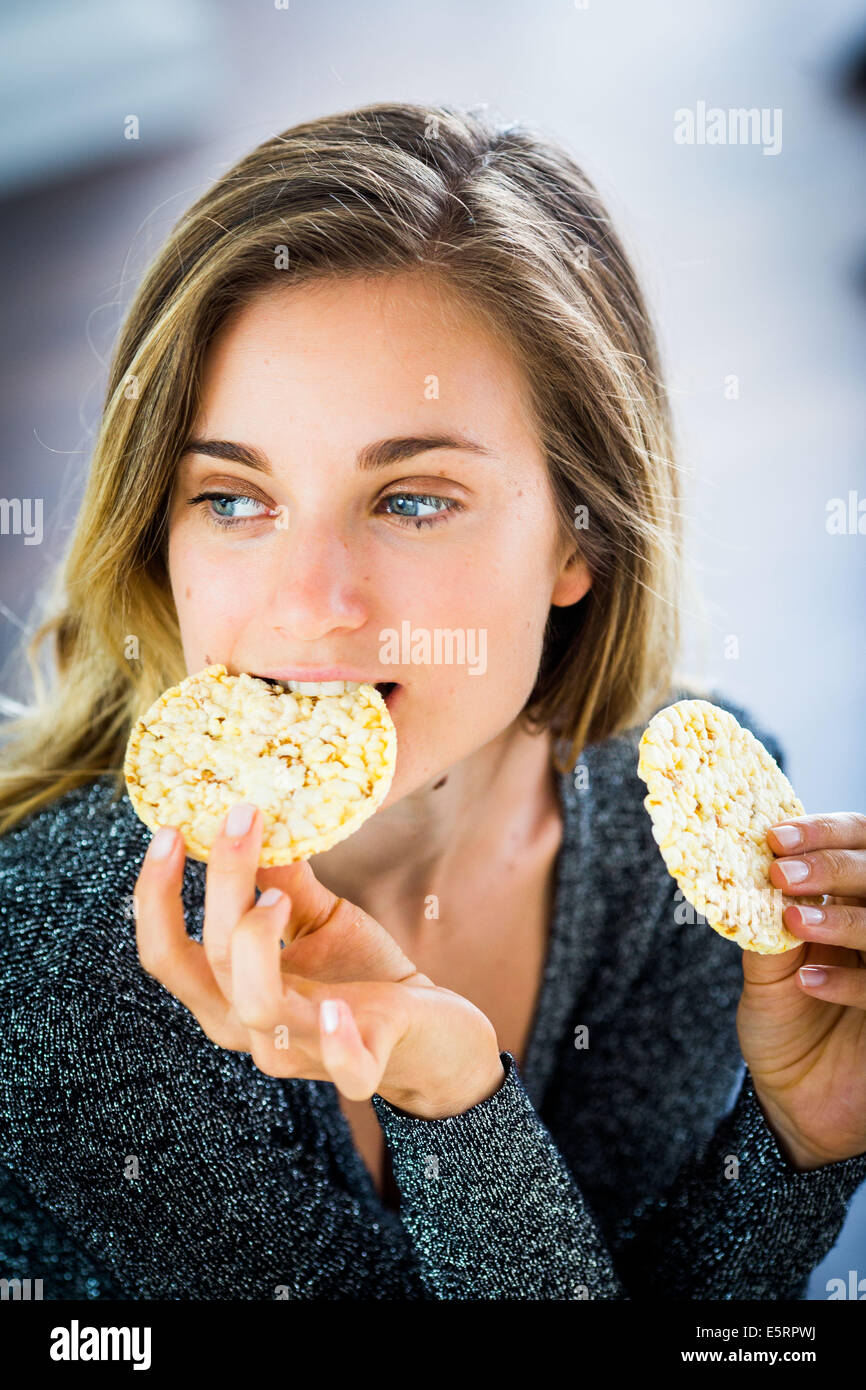 Woman eating a popcorn galette Stock Photo - Alamy