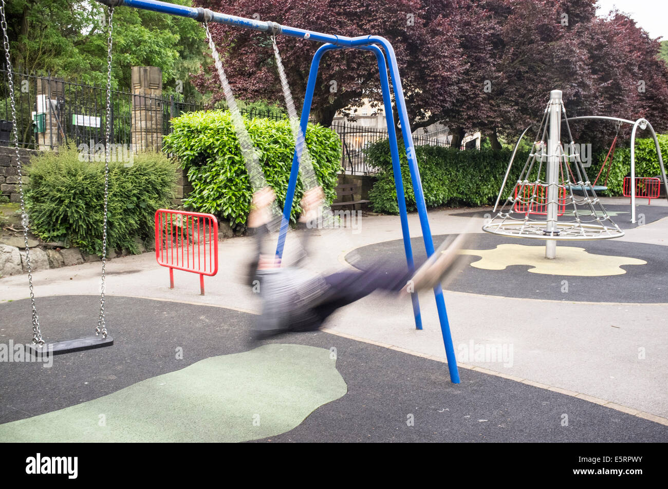 Blurry motion of person on a swing Stock Photo - Alamy