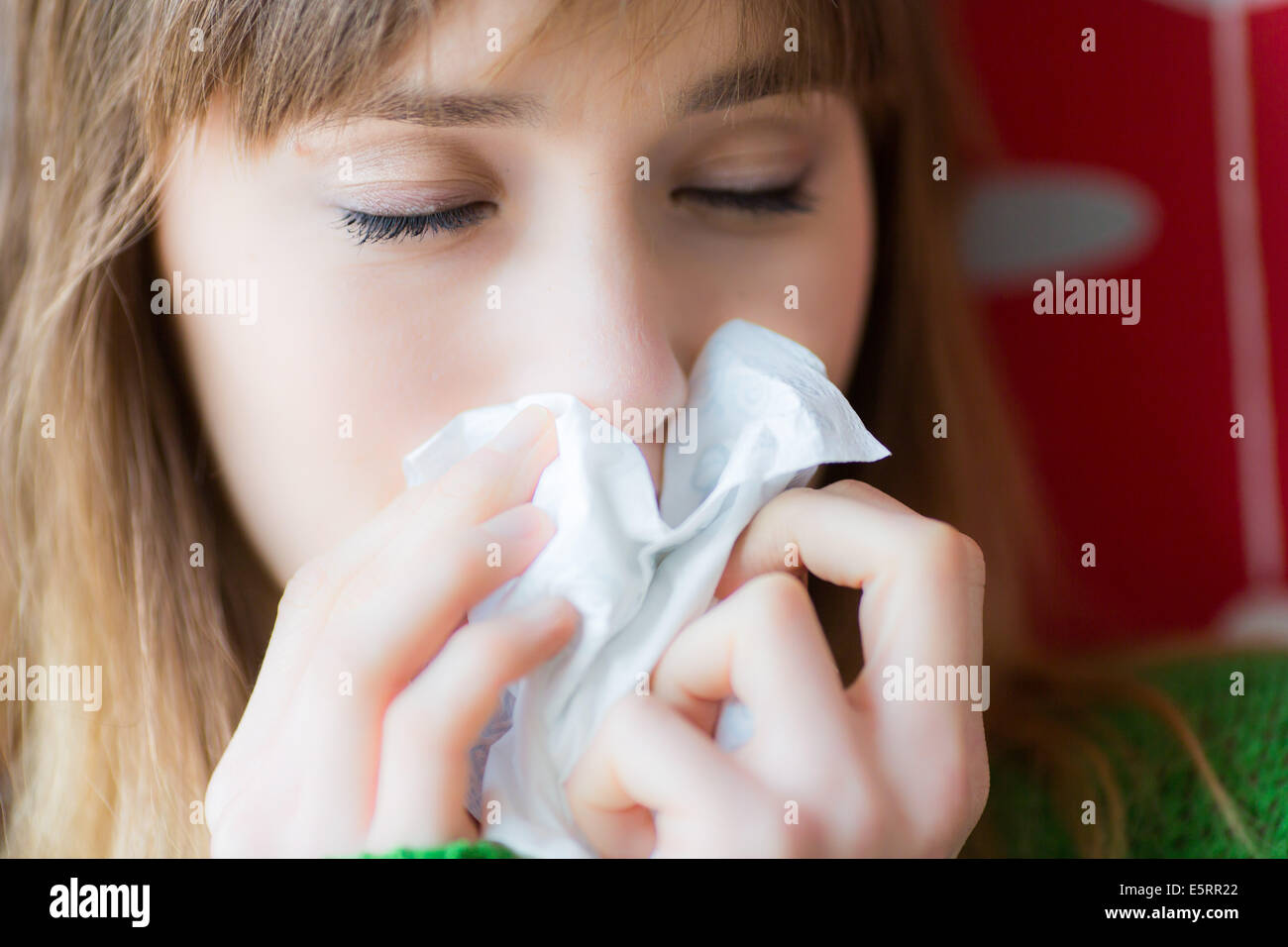 Woman with a cold using tissue Stock Photo - Alamy
