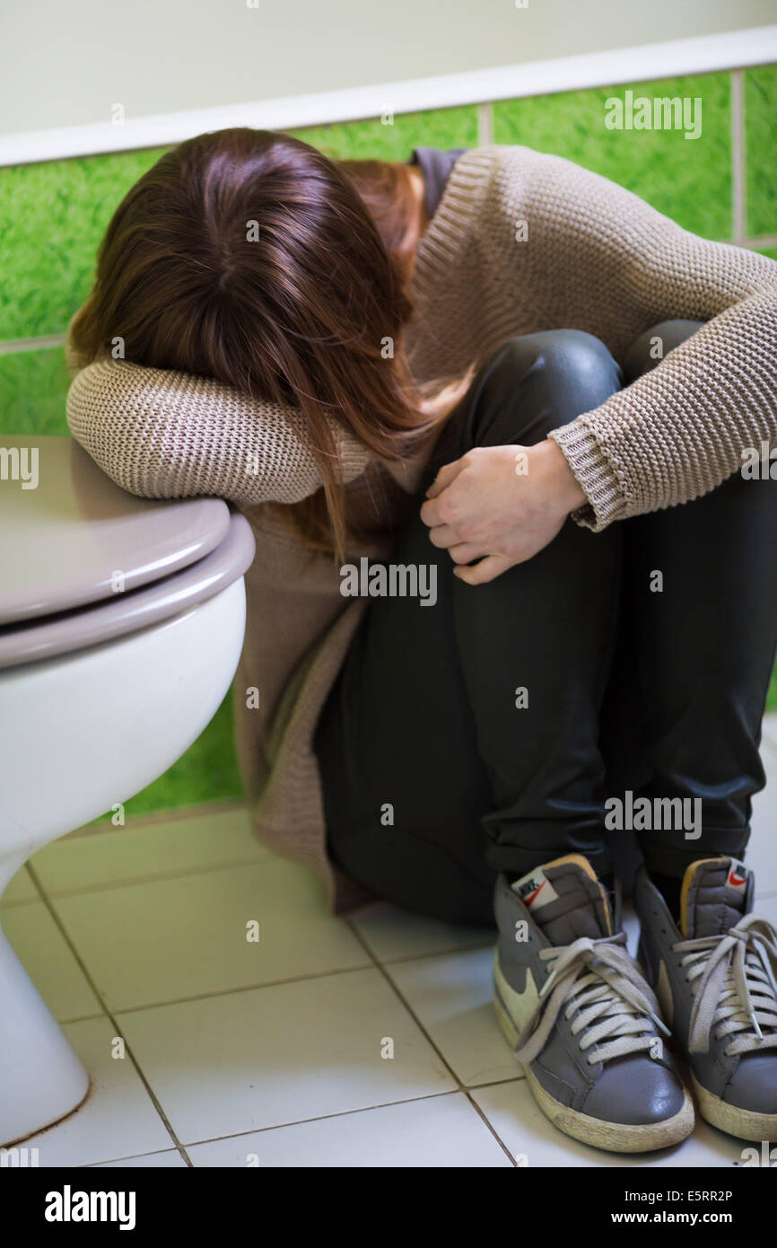 Woman vomiting toilet hi-res stock photography and images - Alamy