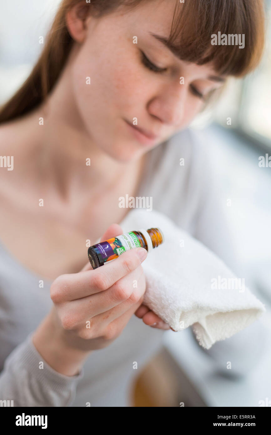 Woman applying essential oil on a tissue Stock Photo - Alamy