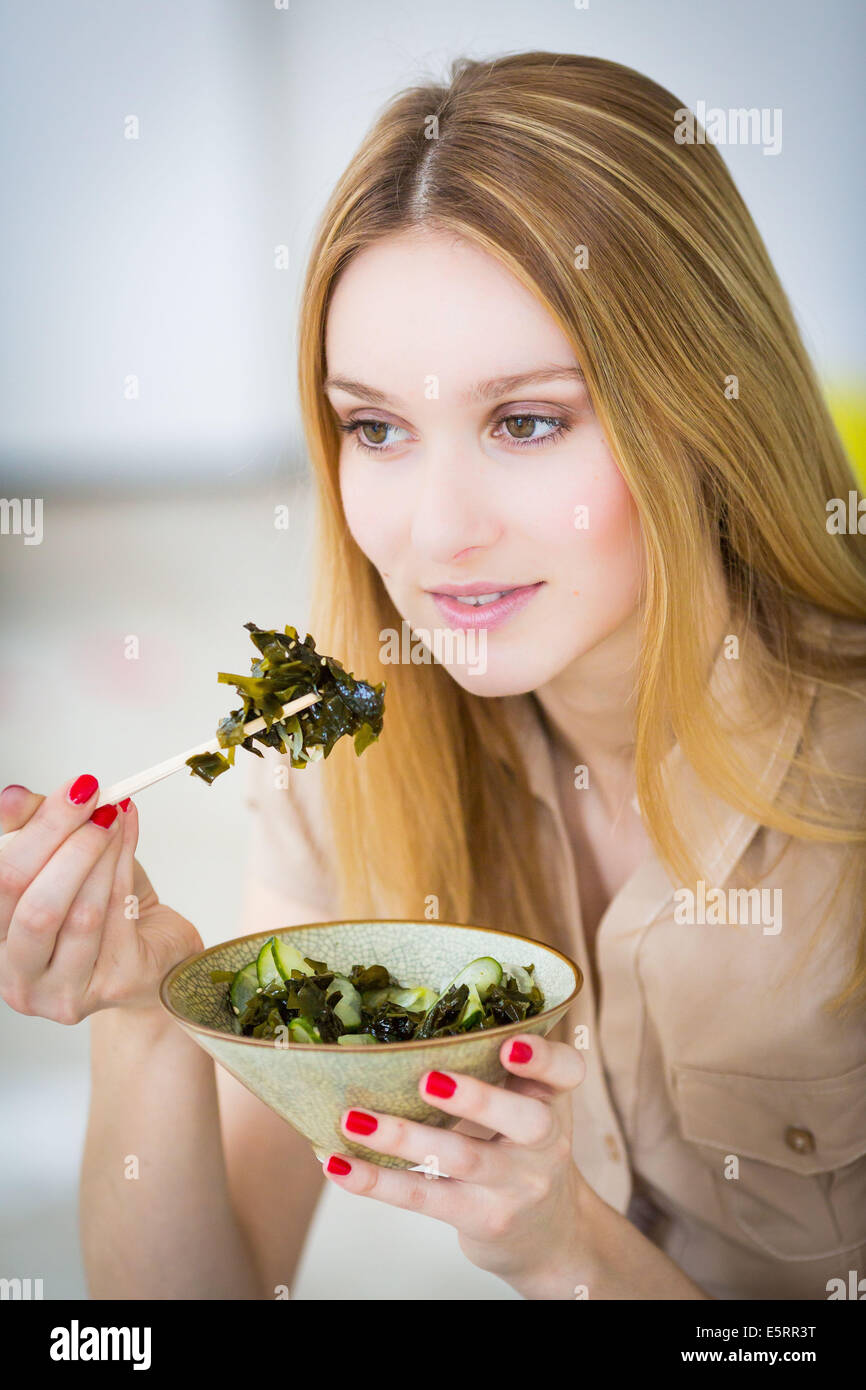 Woman eating edible seaweed Stock Photo - Alamy