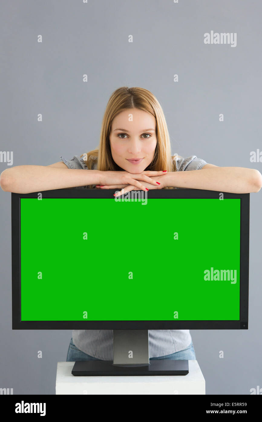 Woman standing behind a computer Stock Photo - Alamy