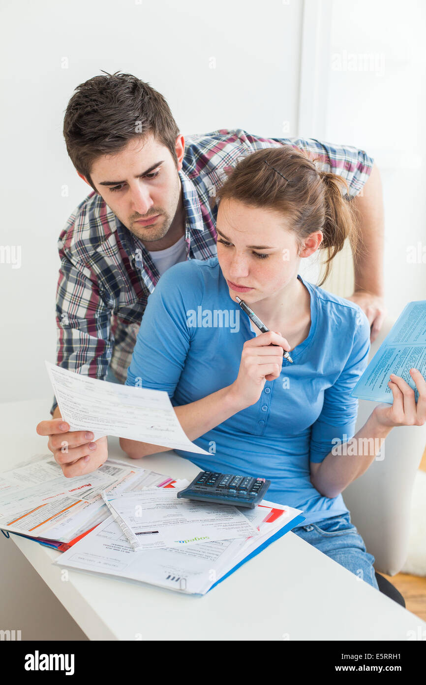 Young couple doing paperwork together Stock Photo - Alamy