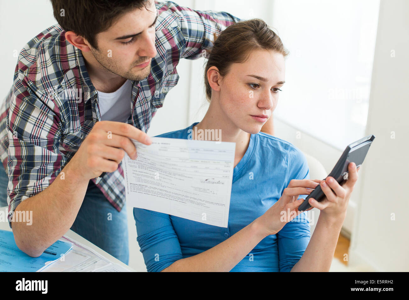 Young couple doing calculation hi-res stock photography and images - Alamy