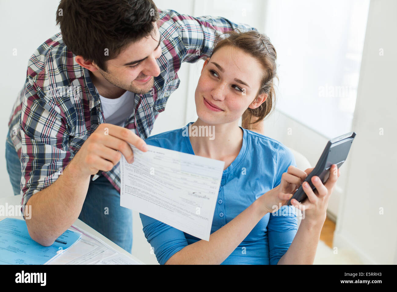 Young couple doing paperwork together Stock Photo - Alamy
