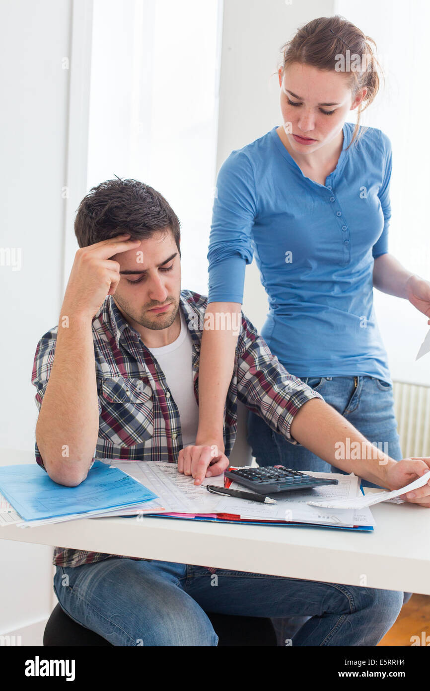 Young couple doing paperwork together Stock Photo - Alamy