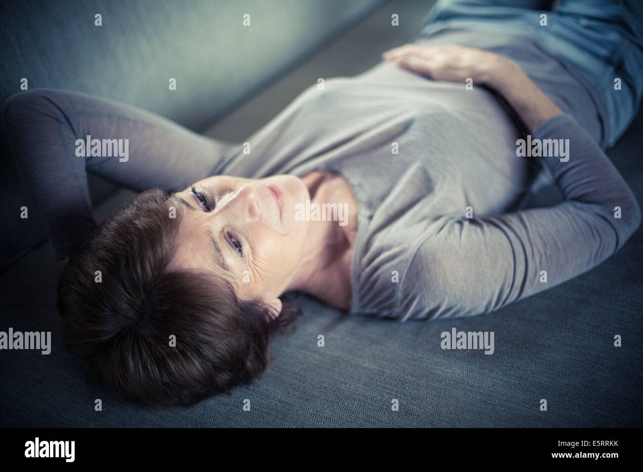 Senior woman napping on couch Stock Photo - Alamy
