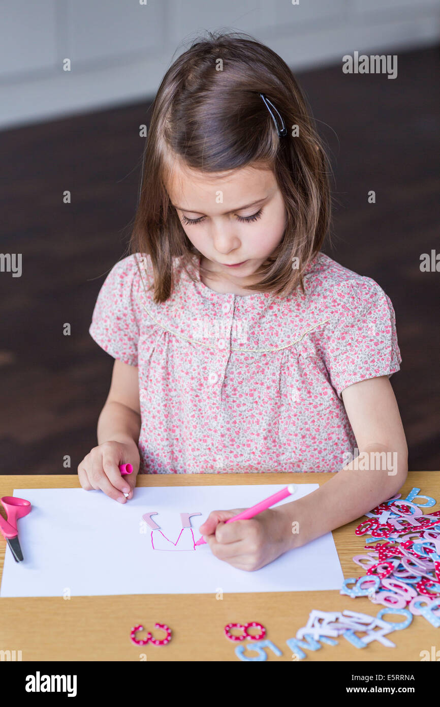 5 year old girl doing manual activity Stock Photo - Alamy