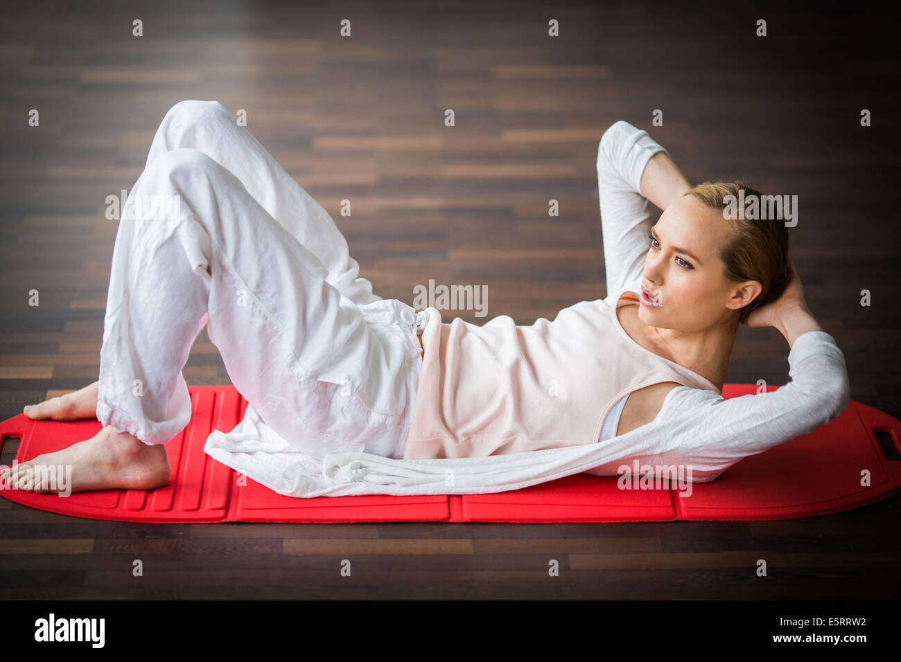 Woman practicing stretching exercises to relieve back pain Stock Photo ...