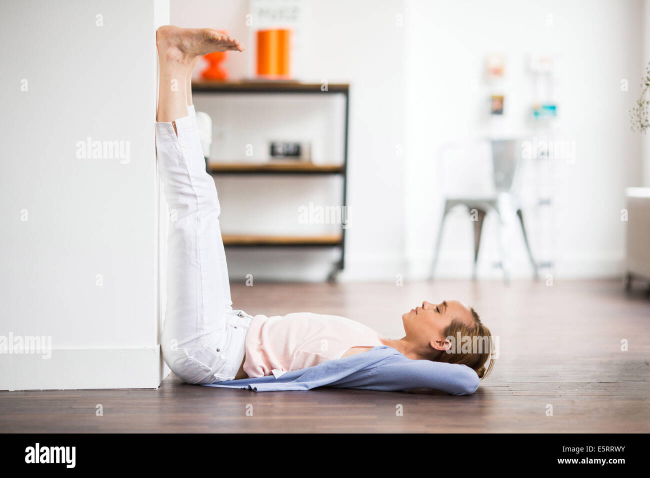 Woman practicing stretching exercises to relieve back pain Stock Photo ...