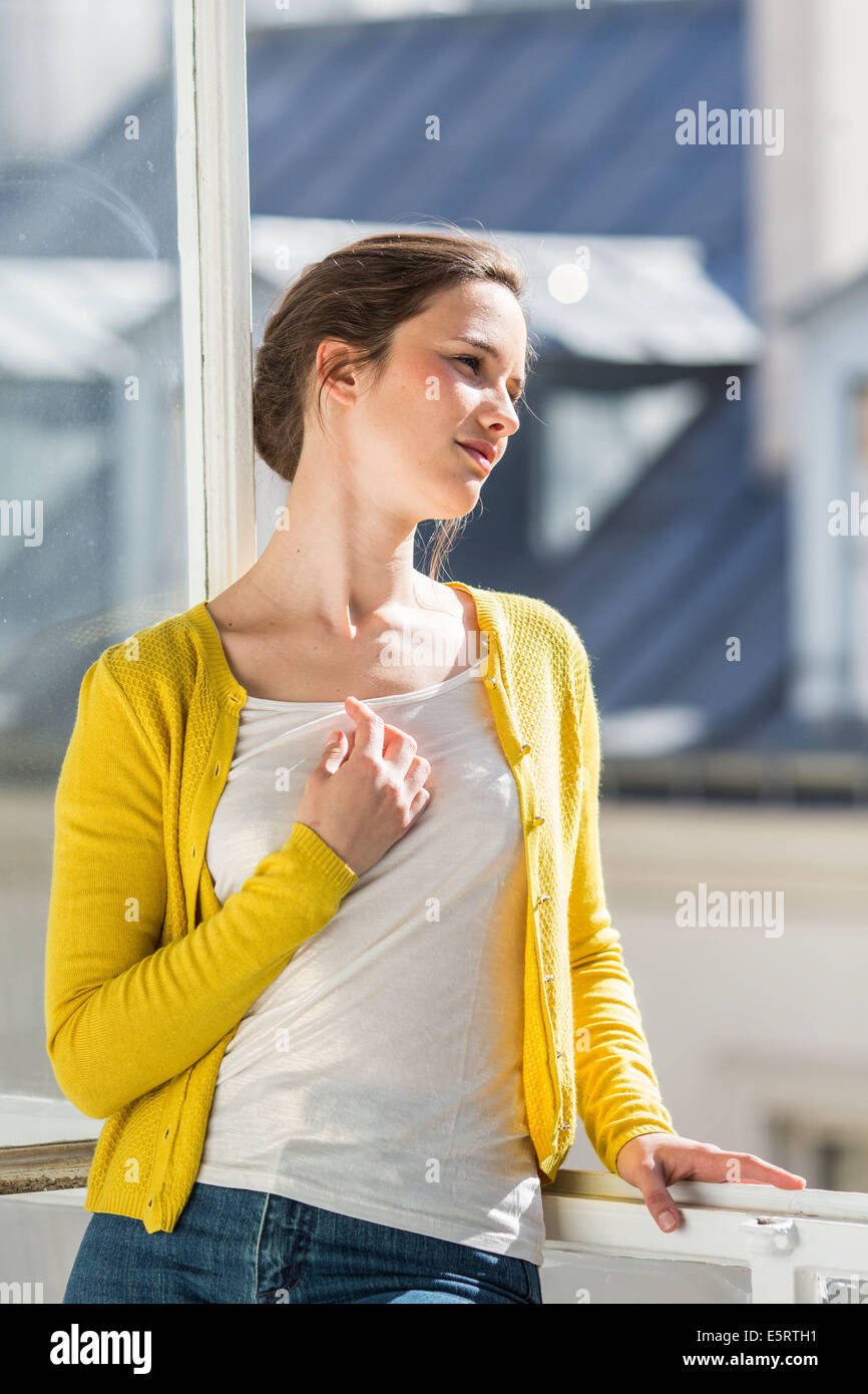Woman looking through the window Stock Photo - Alamy