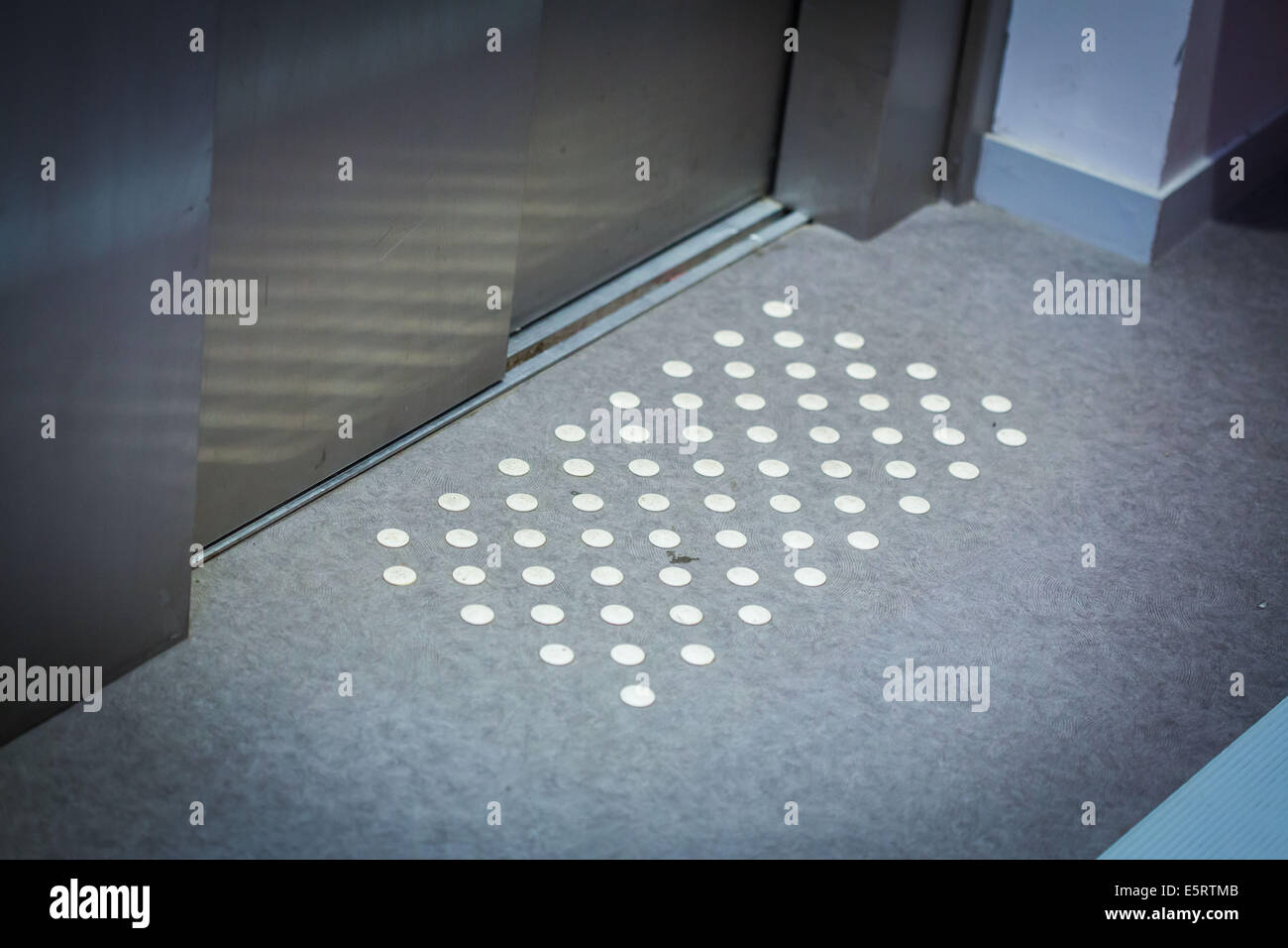 Hazard warning tape for the visually impaired to an elevator door Stock ...