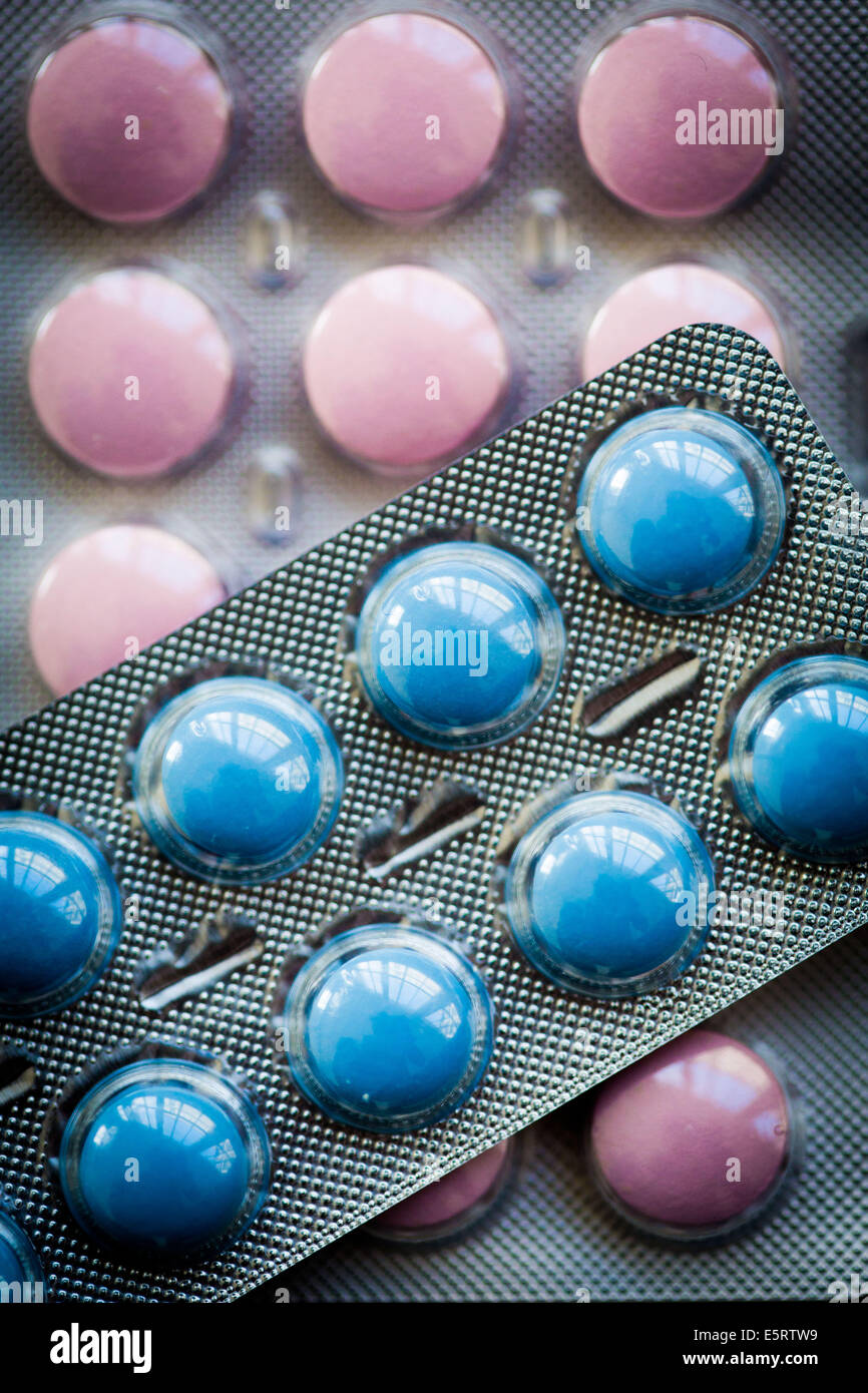 Blue and pink tablets, image illustrating a different dosage depending ...