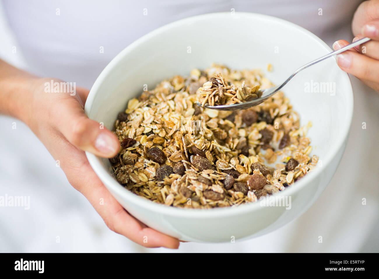 Woman eating cereals Stock Photo - Alamy