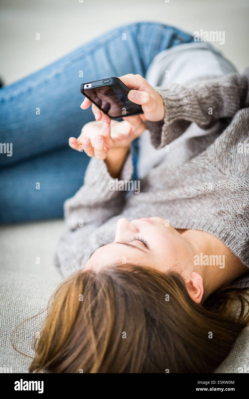 Woman touching the screen of an iphone® Stock Photo - Alamy