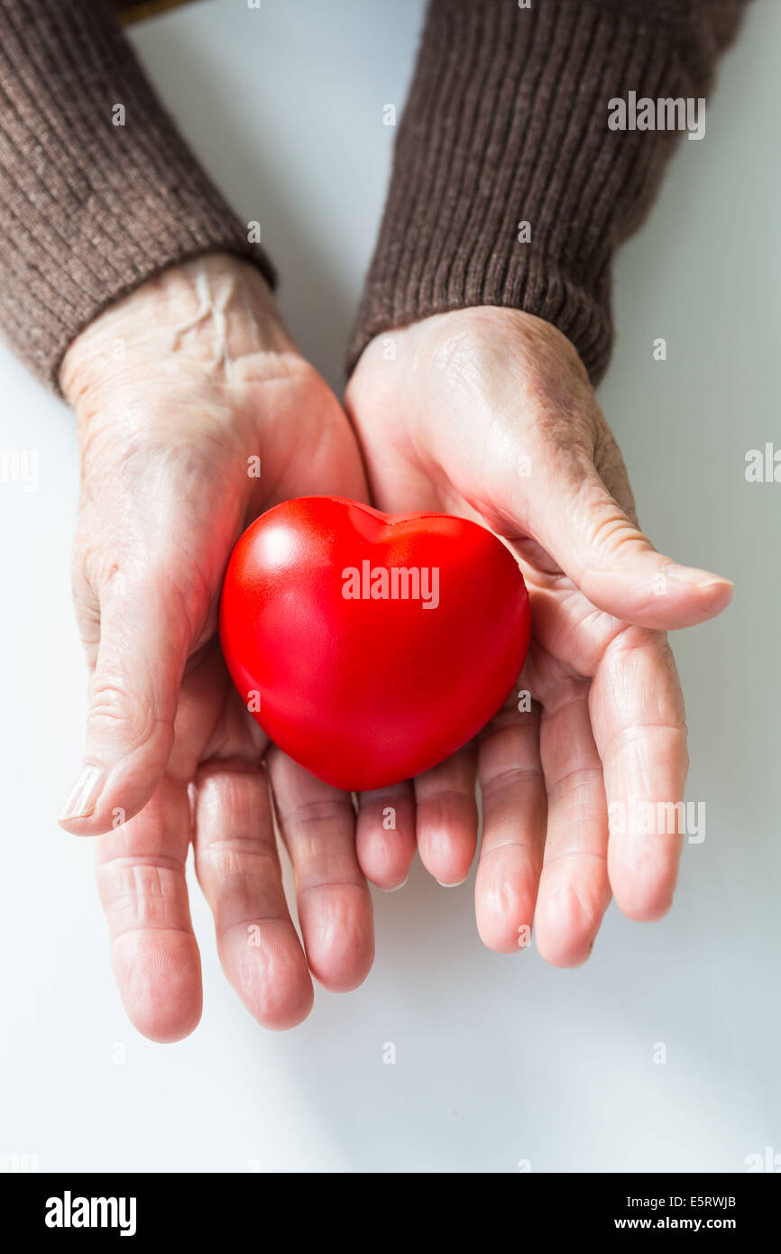 Woman holding heart Stock Photo - Alamy