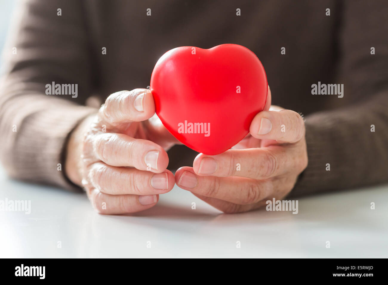 Woman holding heart Stock Photo - Alamy