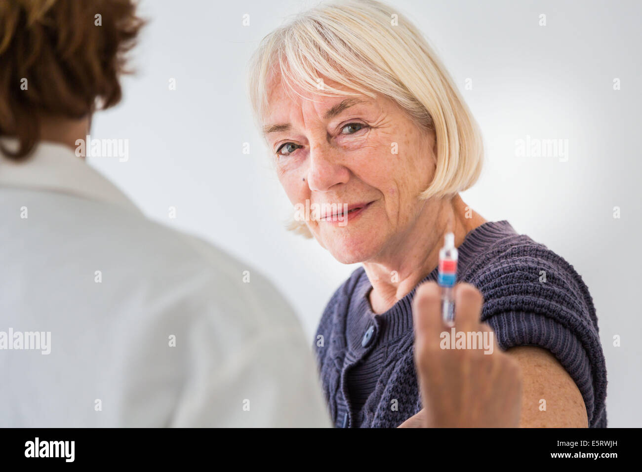 Woman receiving vaccination Stock Photo - Alamy