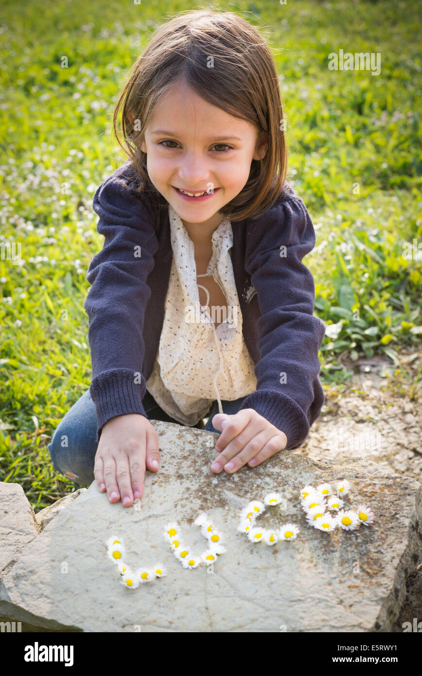 Girl behind her first name written with flowers Stock Photo - Alamy