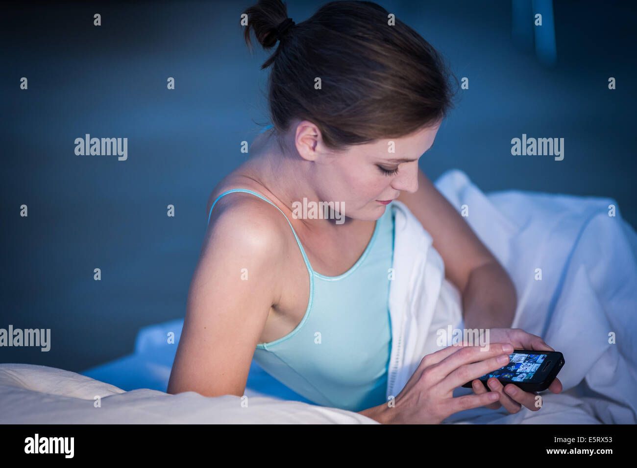Woman touching the screen of an iphone® Stock Photo - Alamy