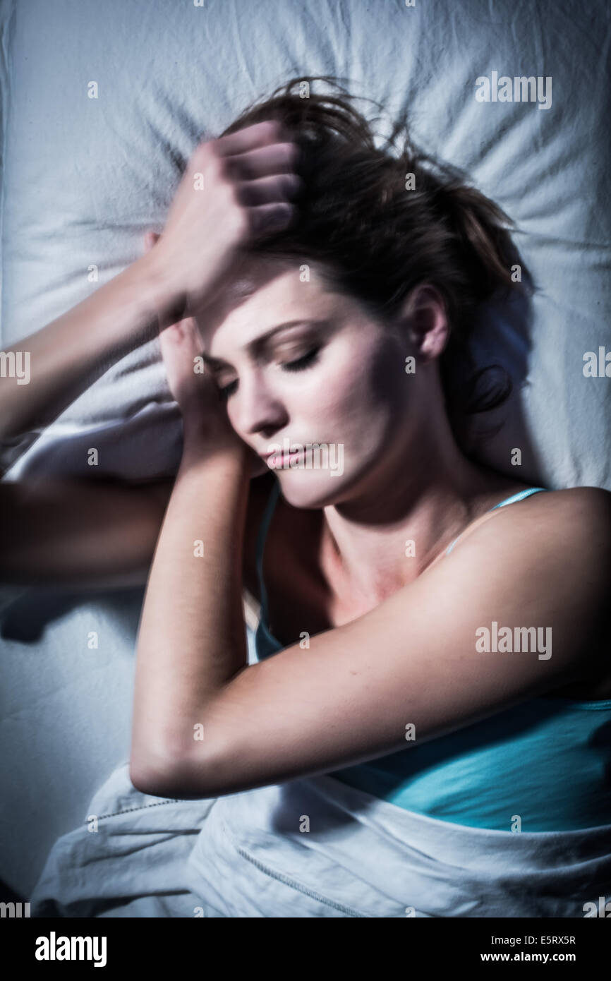 Woman resting in bed Stock Photo - Alamy