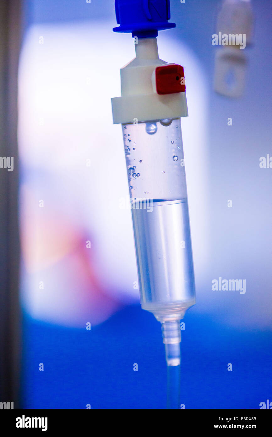 Close-up of the drip chamber of an intravenous (IV) drip attached to a ...
