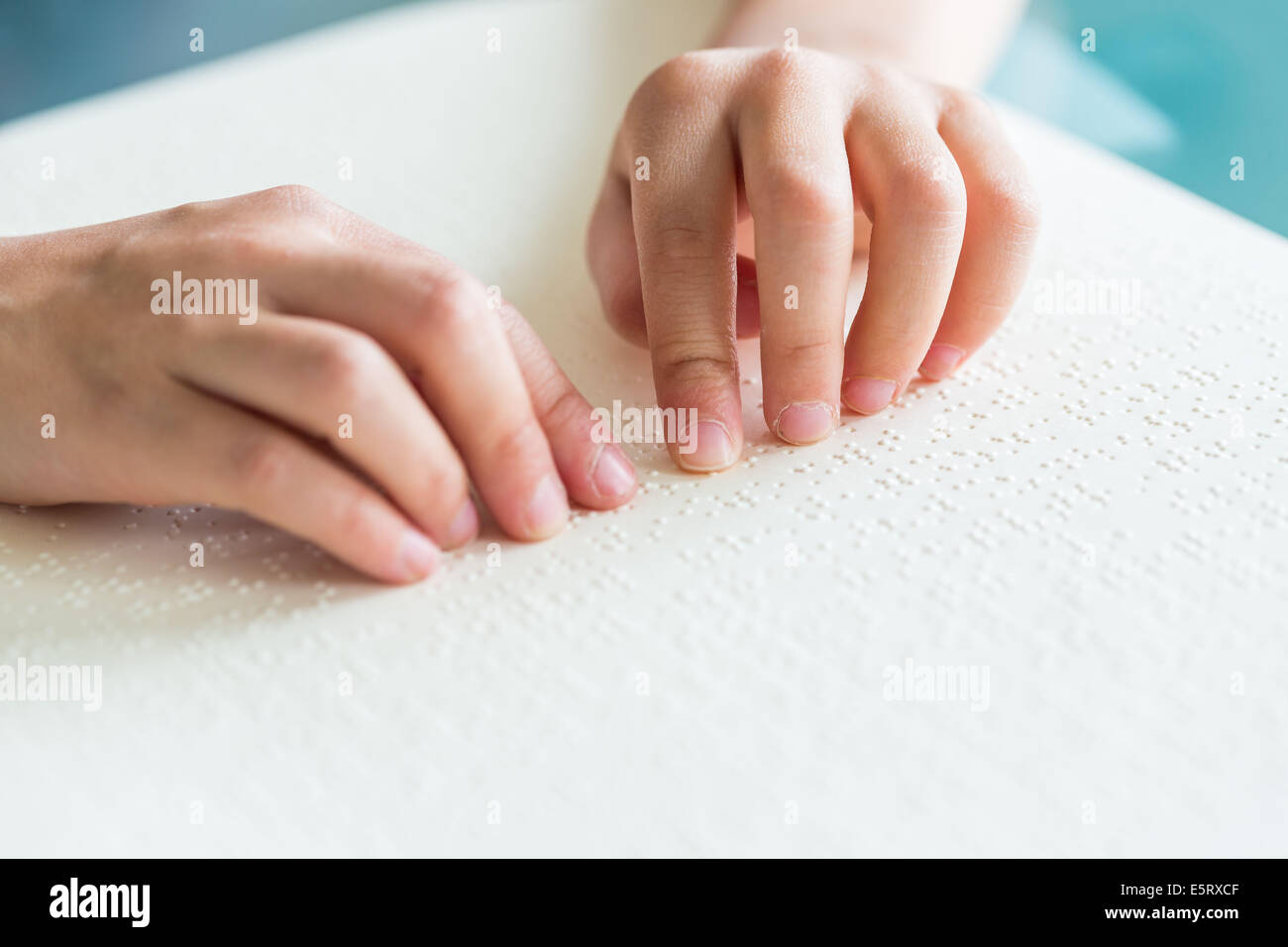 Hands of a blind child reading braille Stock Photo - Alamy