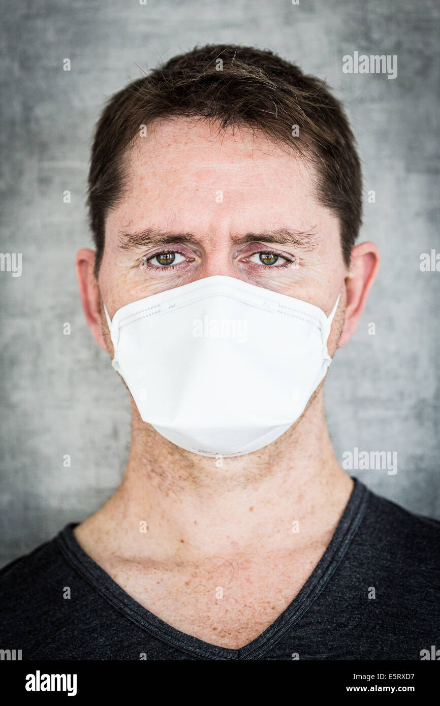 Man wearing a face mask to protect himself from MERS-CoV Stock Photo ...