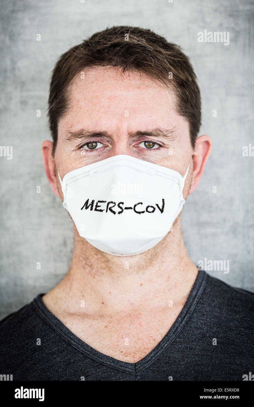Man wearing a face mask to protect himself from MERS-CoV. Man Stock ...